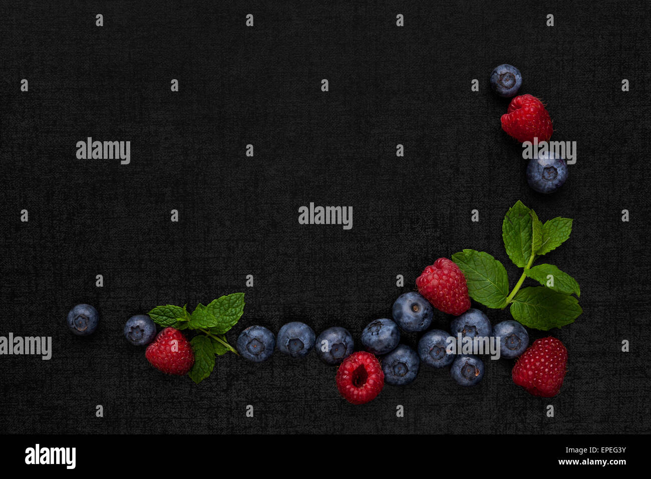 Berry fruit background with copyspace. Raspberries and blueberries with ...