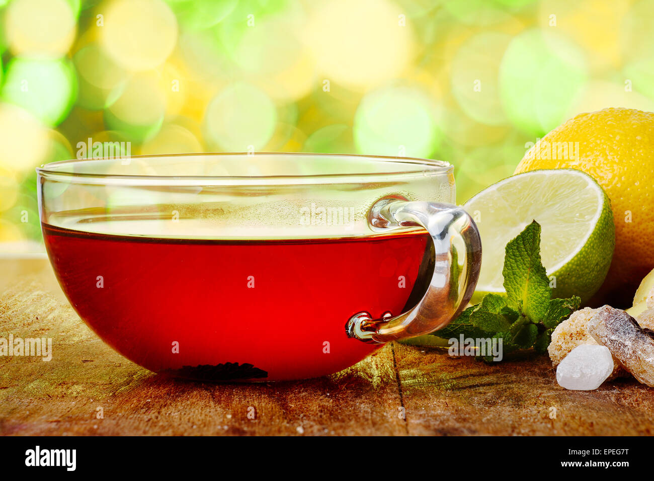 A cup of hot tea on wooden table against spring blurred background. Tea ...