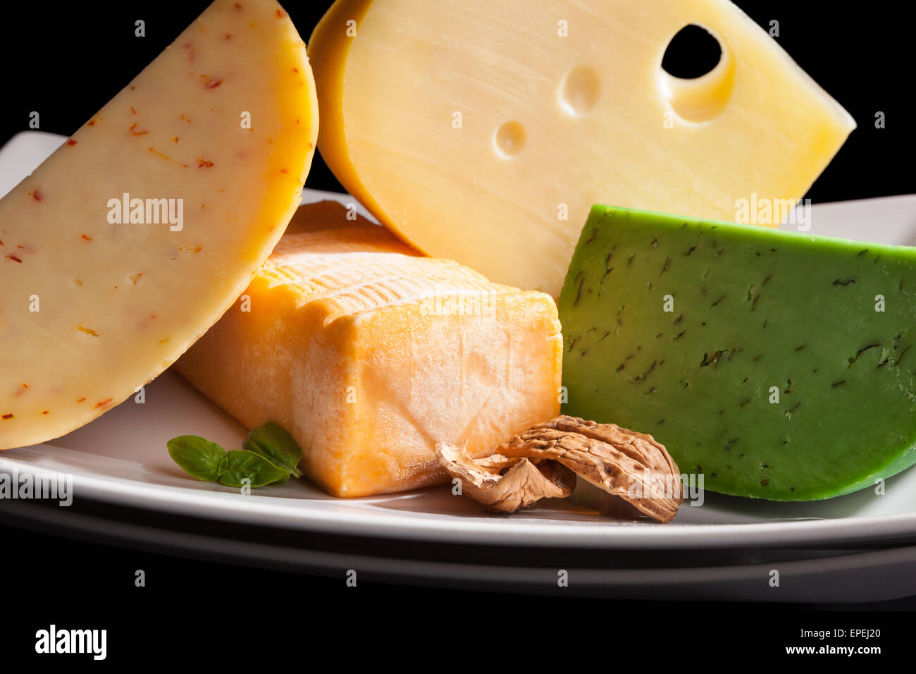 Colorful culinary cheese variation on black background. Gourmet cheese ...