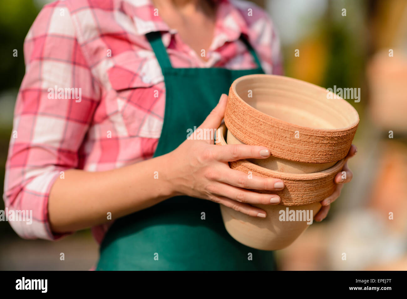 Female gardener holding pots hi-res stock photography and images - Alamy