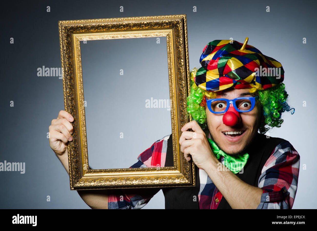 Funny clown with picture frame Stock Photo - Alamy