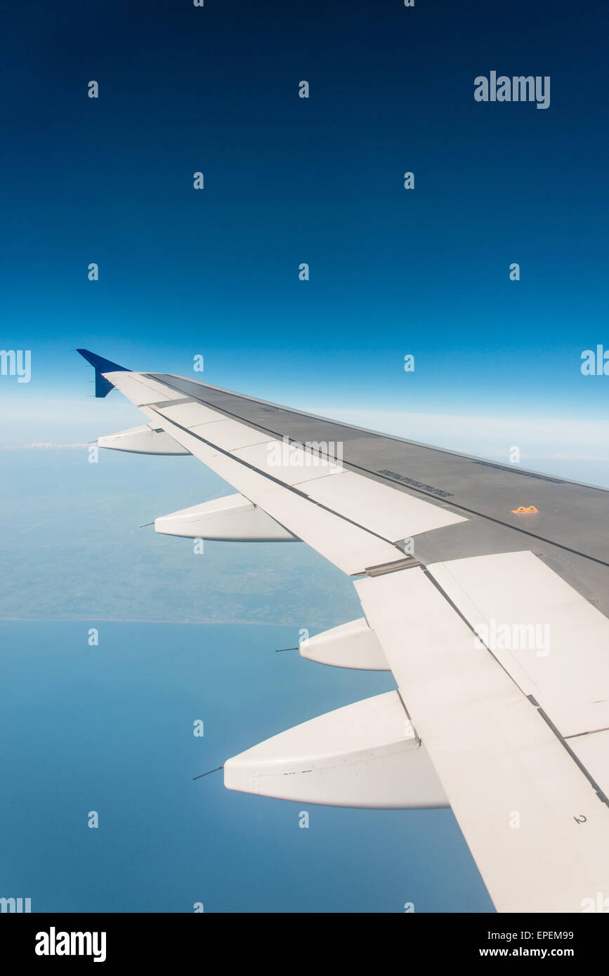 Airplane wing out of window Stock Photo - Alamy
