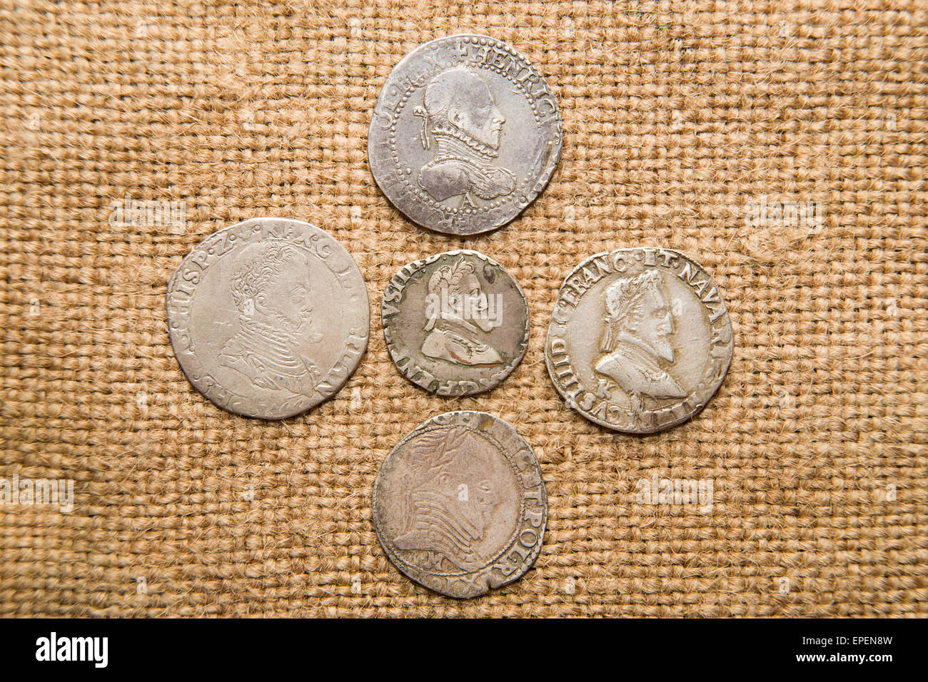 A lot of old coins with portraits of kings on the old cloth Stock Photo ...