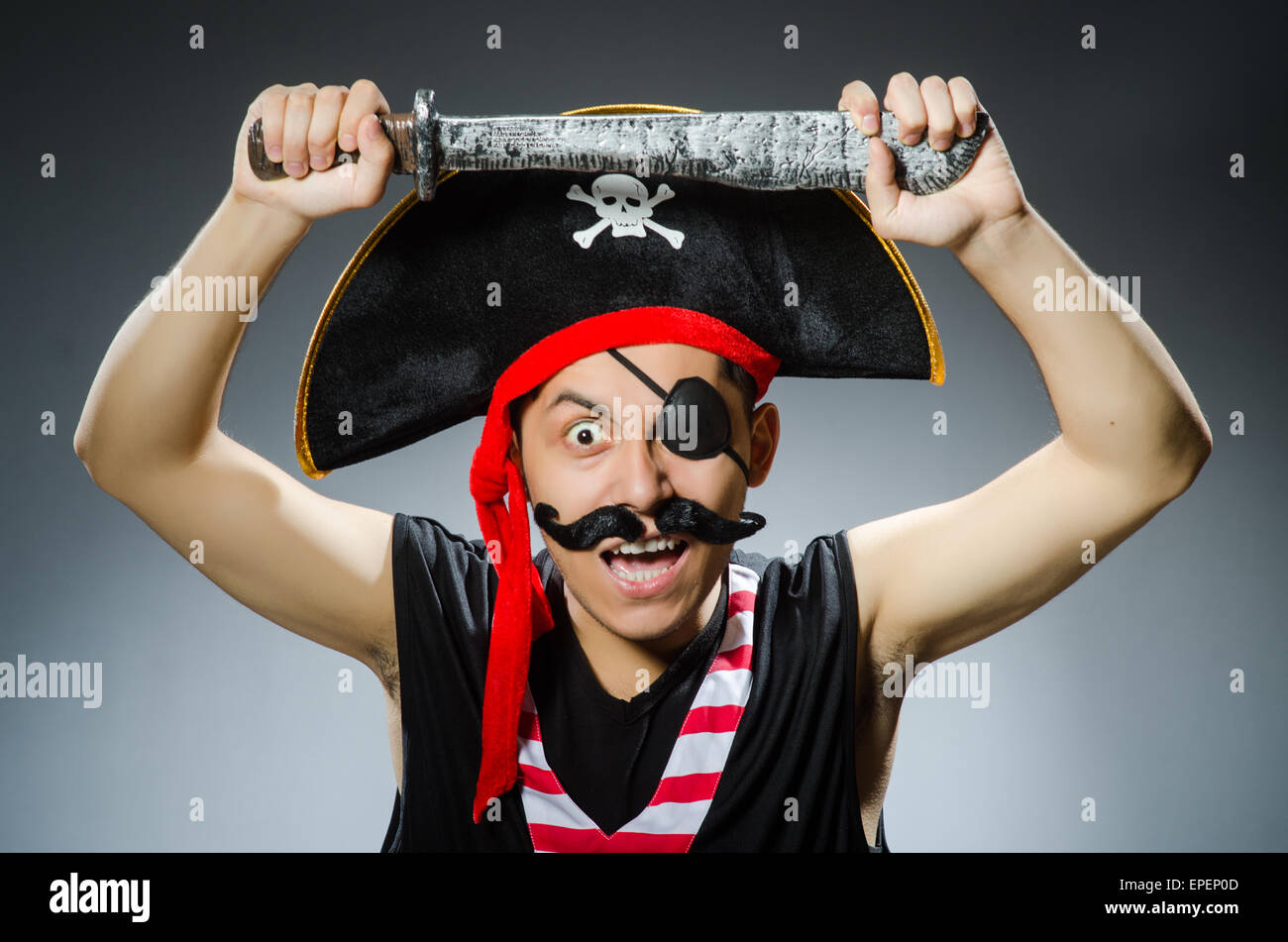 Funny pirate in the dark studio Stock Photo - Alamy