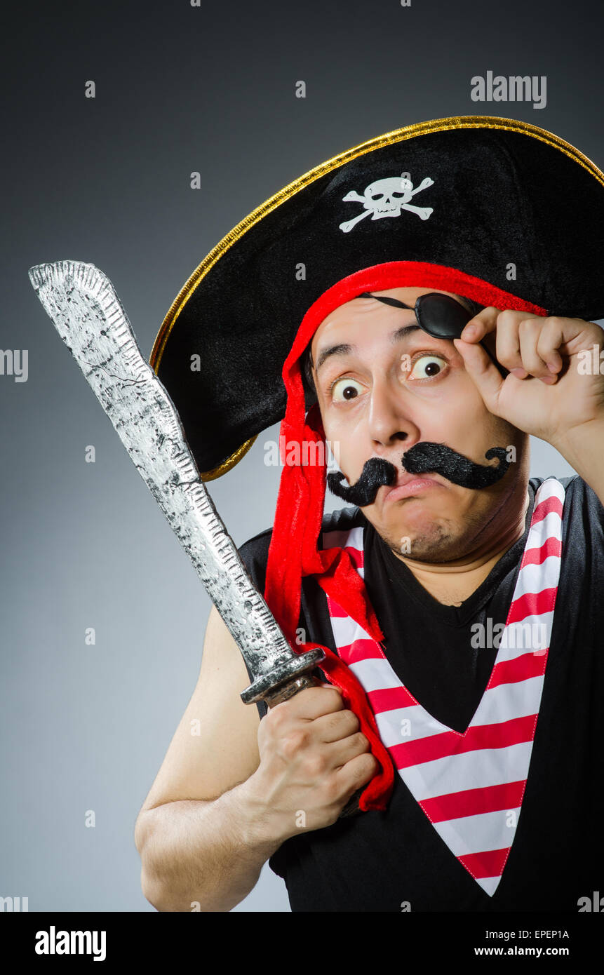 Funny pirate in the dark studio Stock Photo - Alamy