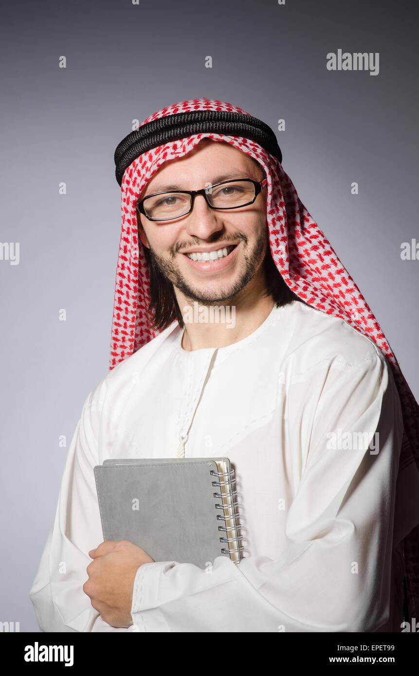 Arab student with book in education concept Stock Photo - Alamy