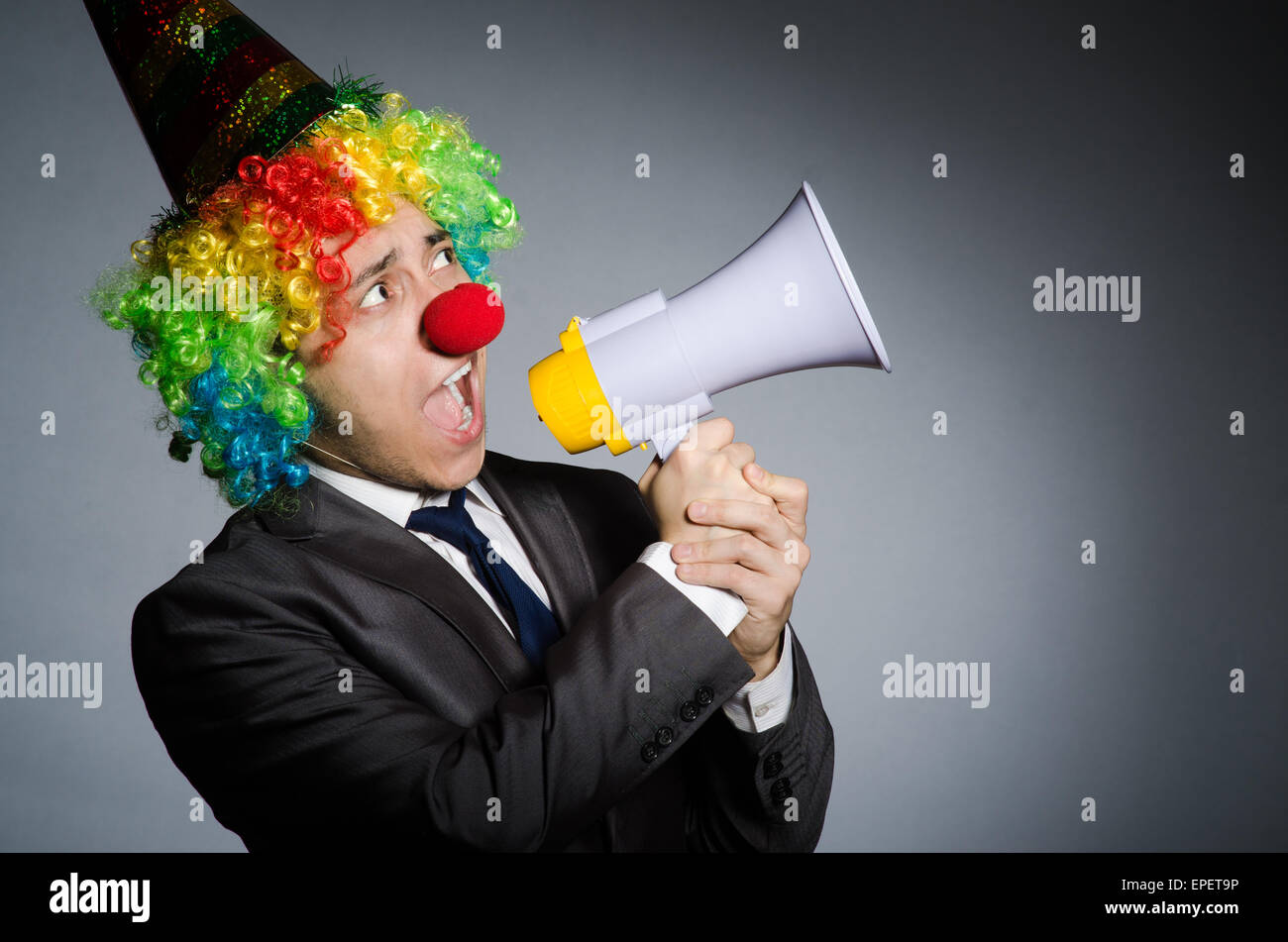 Clown with loudspeaker in funny concept Stock Photo - Alamy