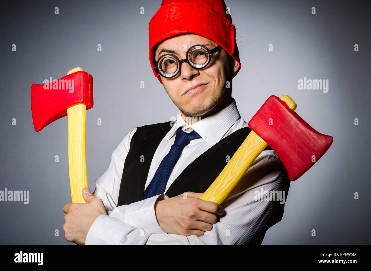 Man with axes in funny concept Stock Photo - Alamy