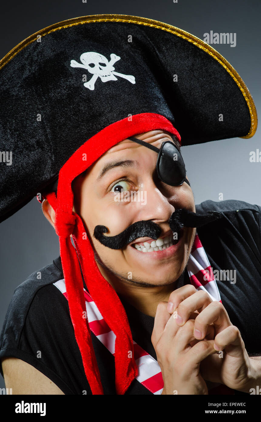 Funny pirate in the dark studio Stock Photo - Alamy