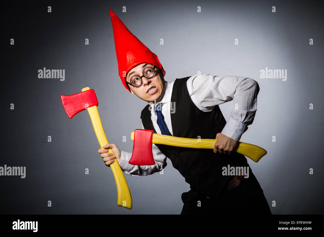 Man with axes in funny concept Stock Photo - Alamy