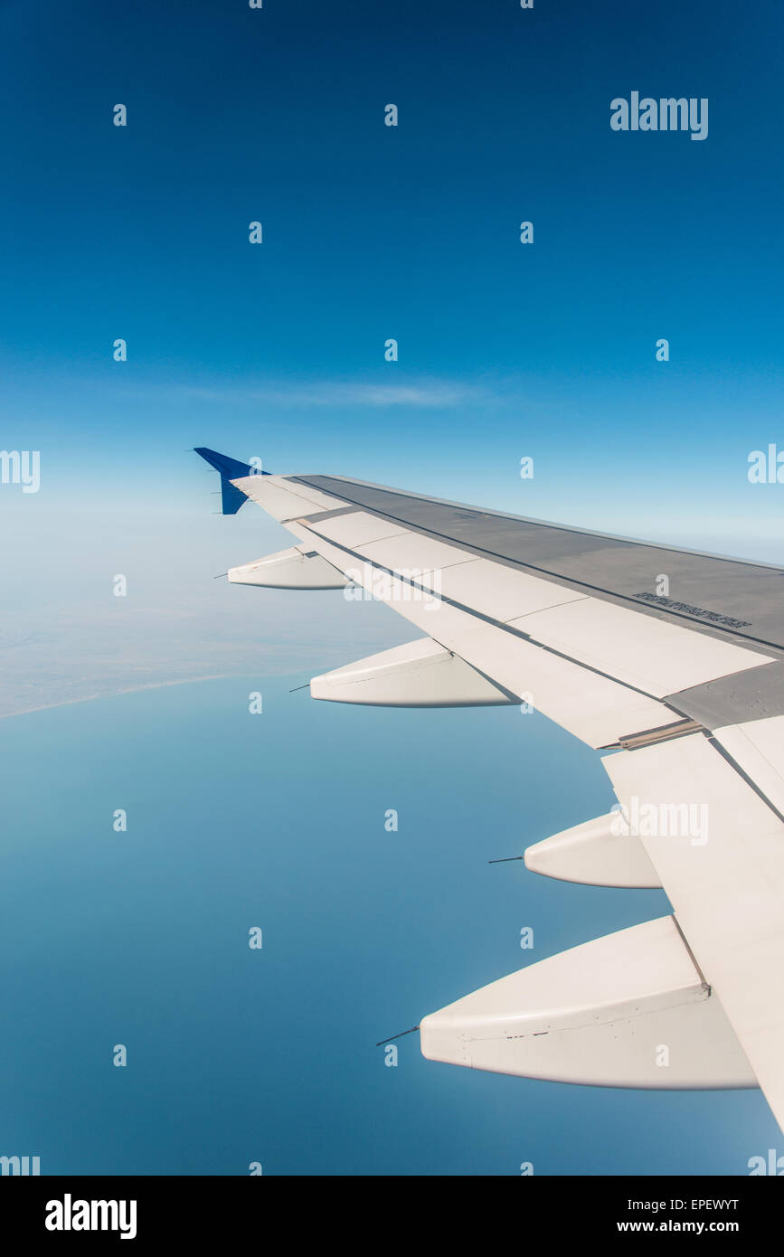 Airplane wing out of window Stock Photo - Alamy