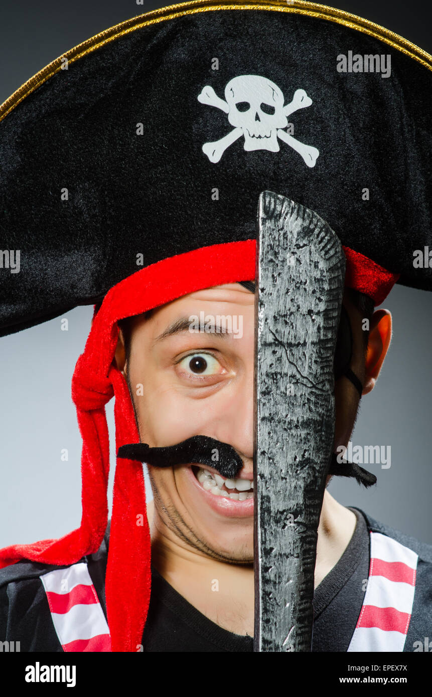 Funny pirate in the dark studio Stock Photo - Alamy
