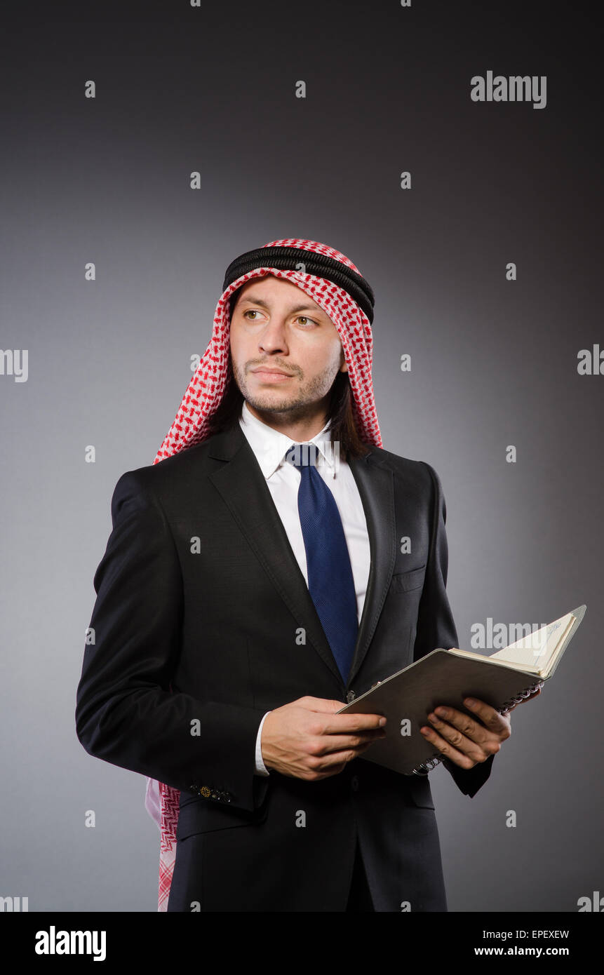 Arab student with book in education concept Stock Photo - Alamy