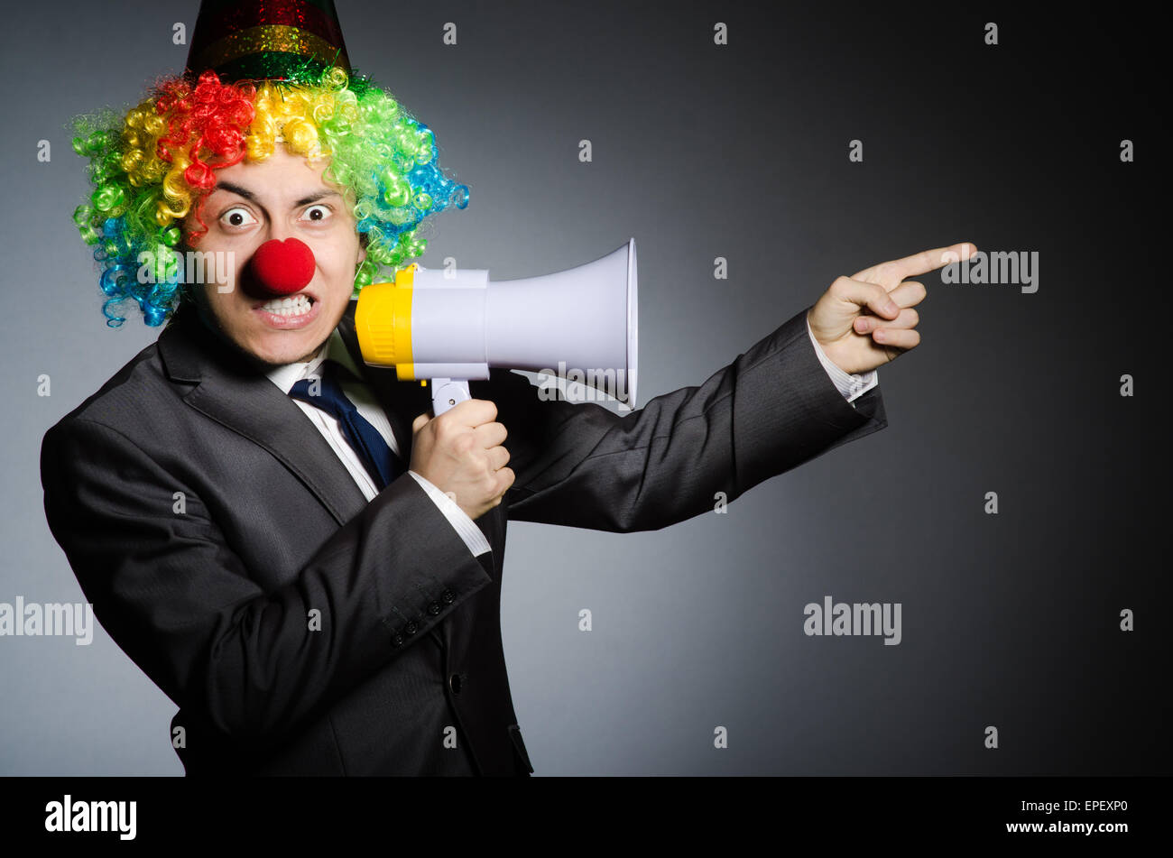 Clown with loudspeaker in funny concept Stock Photo - Alamy