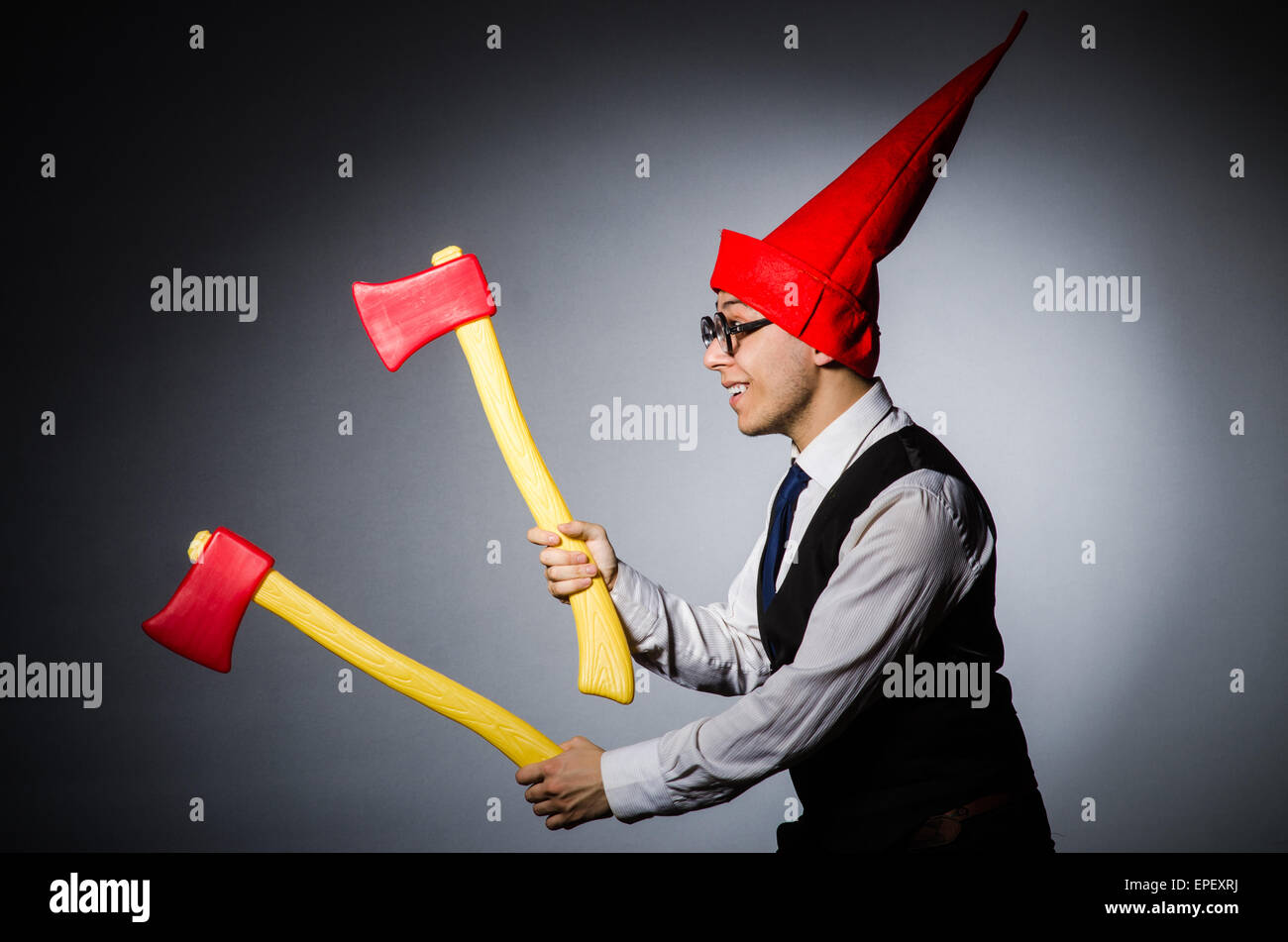 Man with axes in funny concept Stock Photo - Alamy