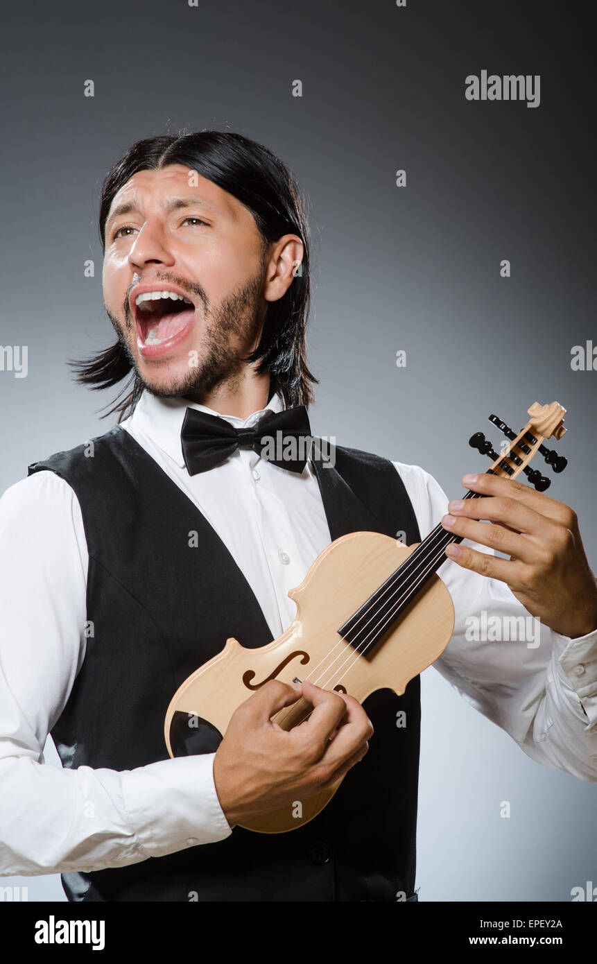 Funny fiddle violin player in musical concept Stock Photo - Alamy