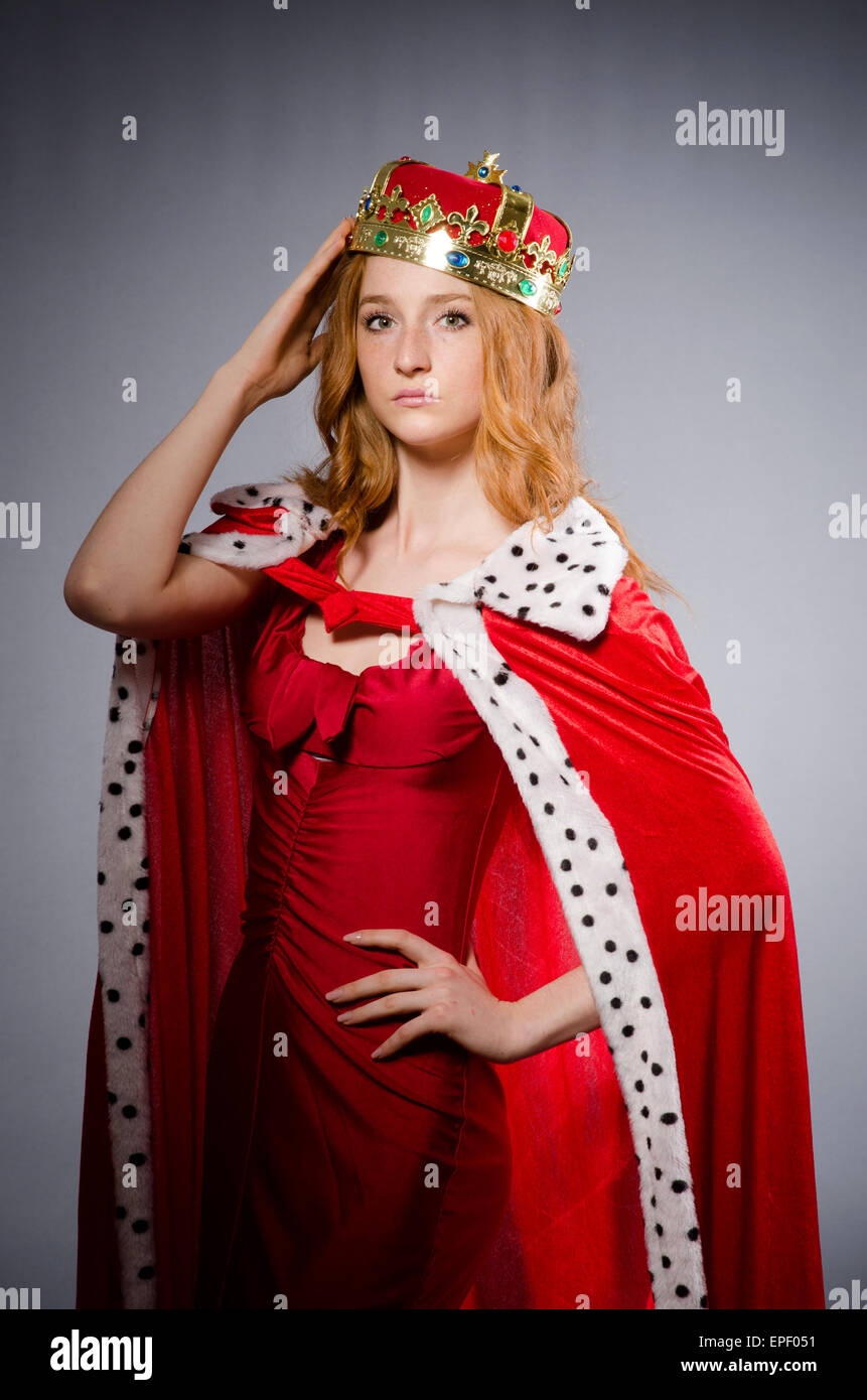 Queen in red dress in studio Stock Photo - Alamy