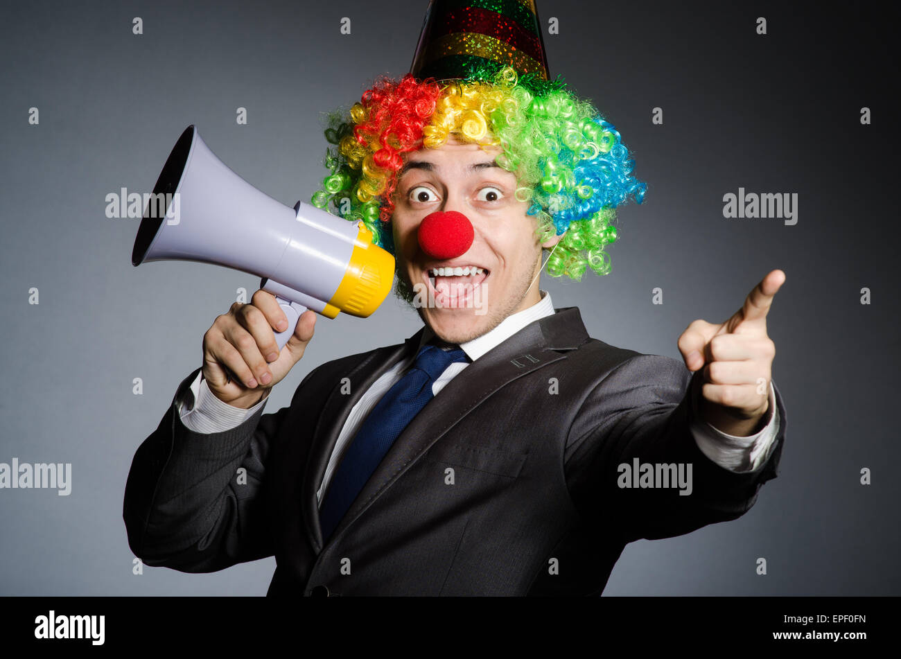 Clown with loudspeaker in funny concept Stock Photo - Alamy