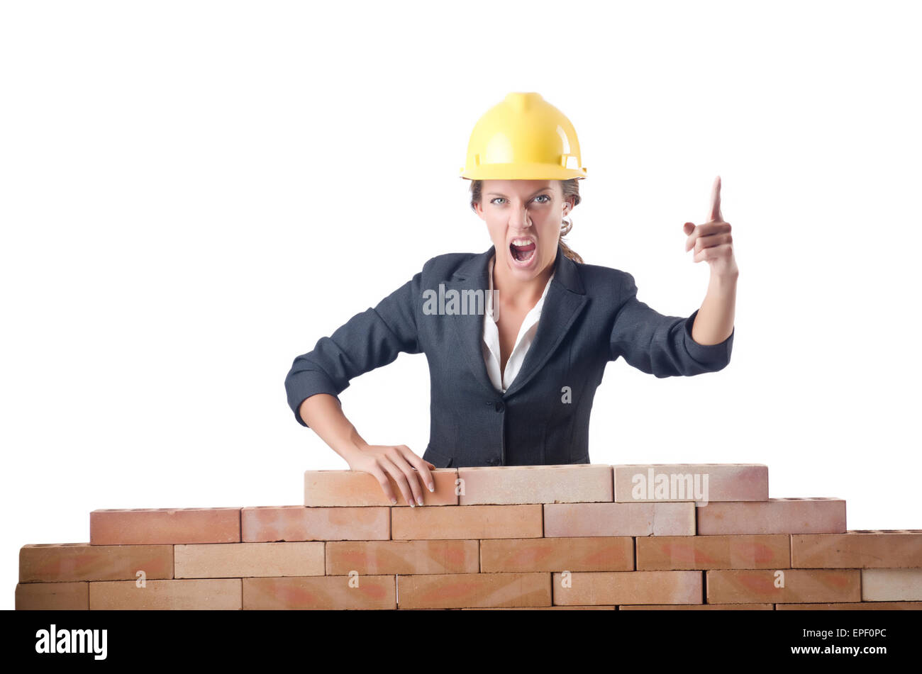 Young female builder near brick wall Stock Photo - Alamy