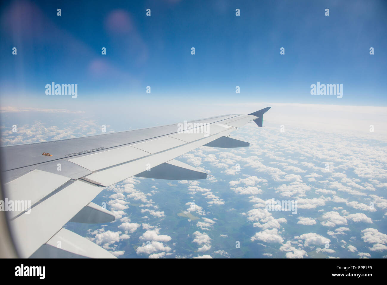 Airplane wing out of window Stock Photo - Alamy
