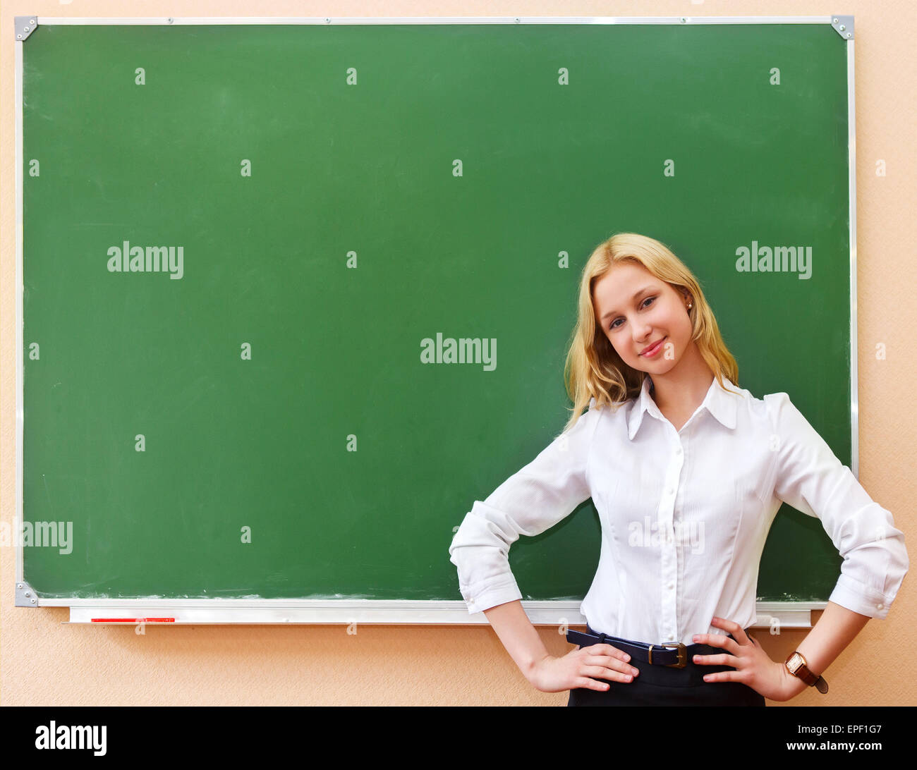 Student girl standing near blackboard Stock Photo - Alamy