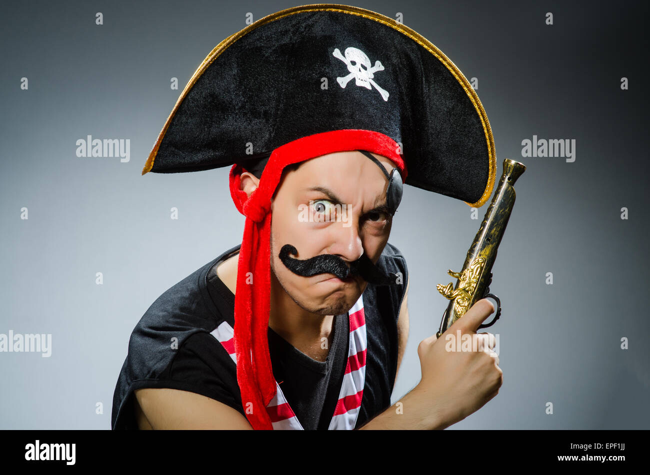 Funny pirate in the dark studio Stock Photo - Alamy