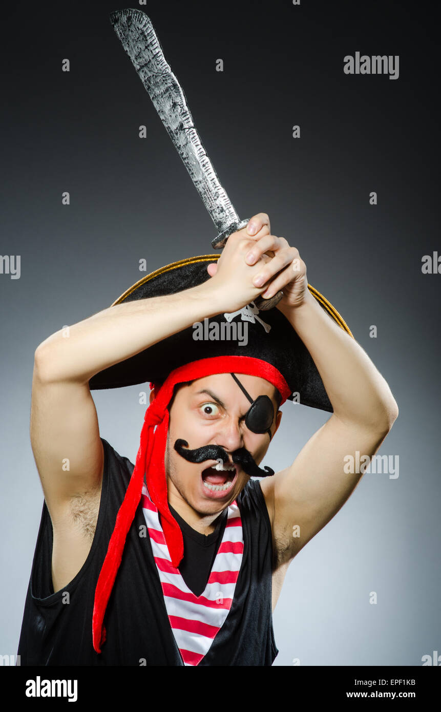 Funny pirate in the dark studio Stock Photo - Alamy