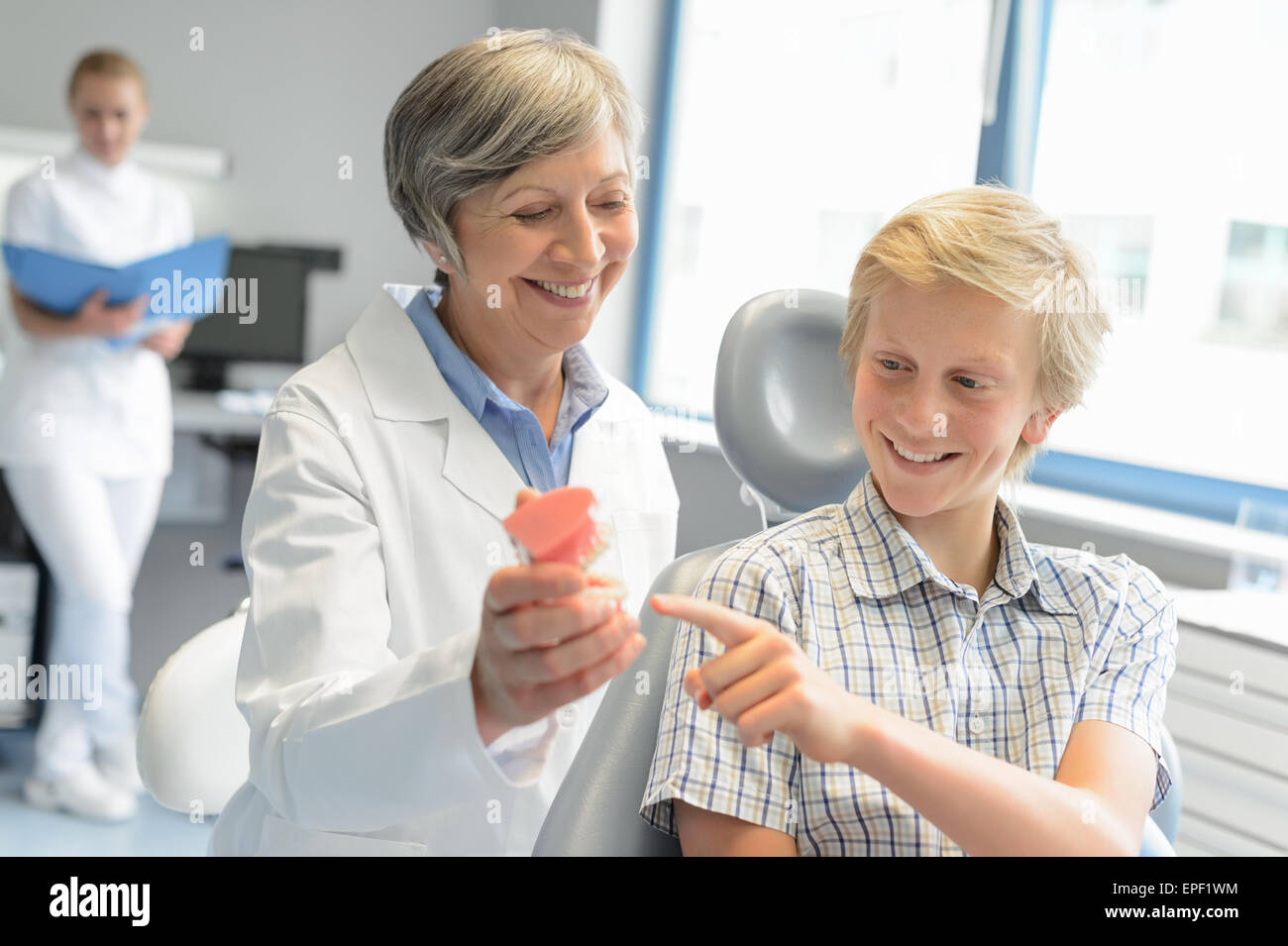 Teenage boy point teeth denture dentist checkup Stock Photo - Alamy