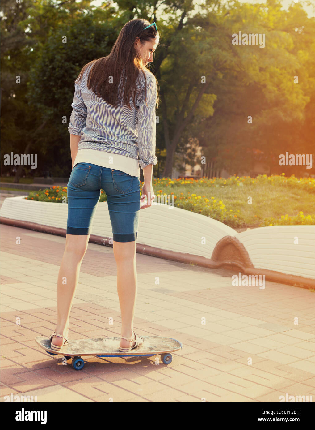 Teen girl on longboard on the street Stock Photo - Alamy