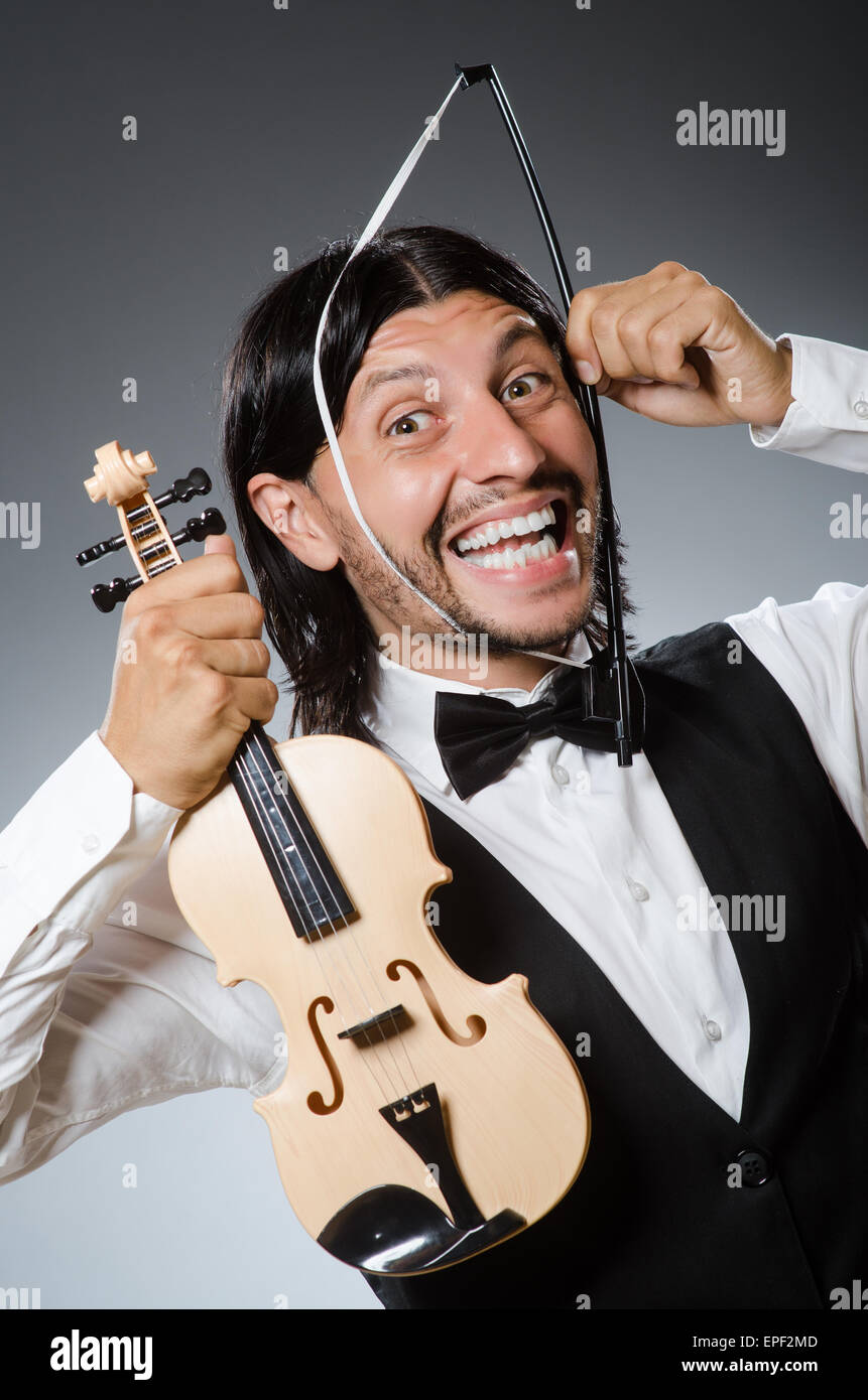 Funny fiddle violin player in musical concept Stock Photo - Alamy