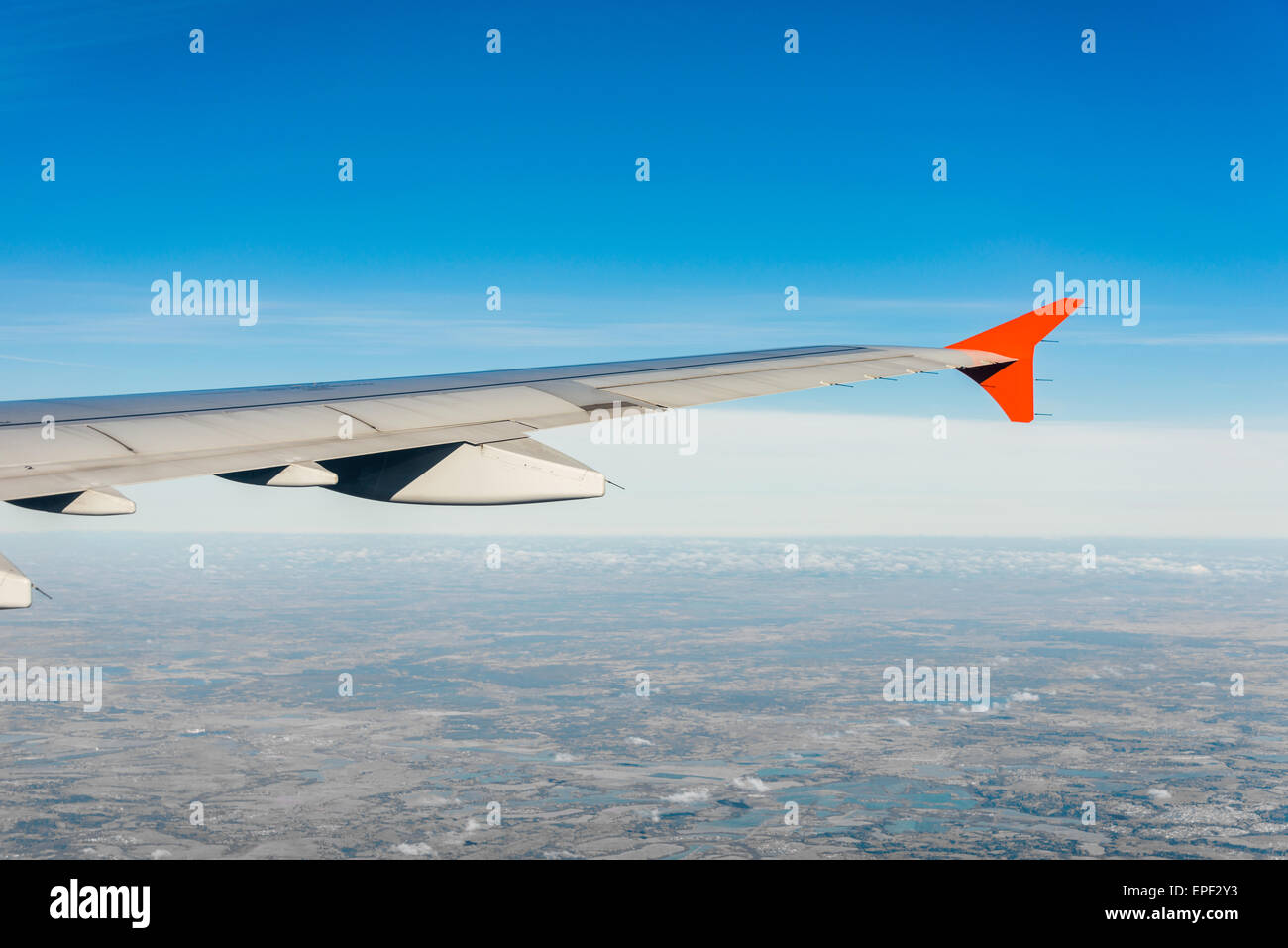 Airplane wing out of window Stock Photo - Alamy