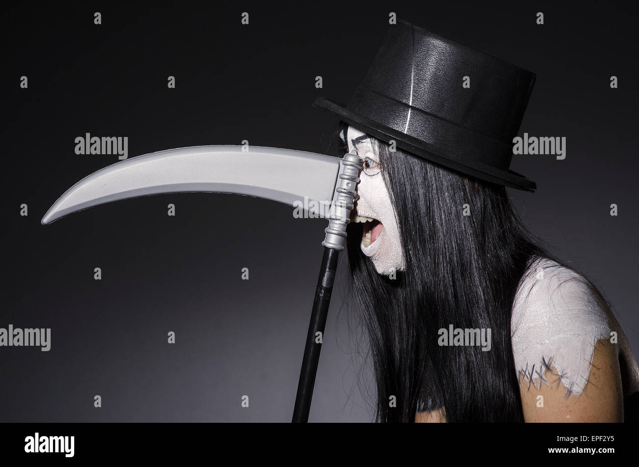 Woman in halloween concept with scythe Stock Photo - Alamy