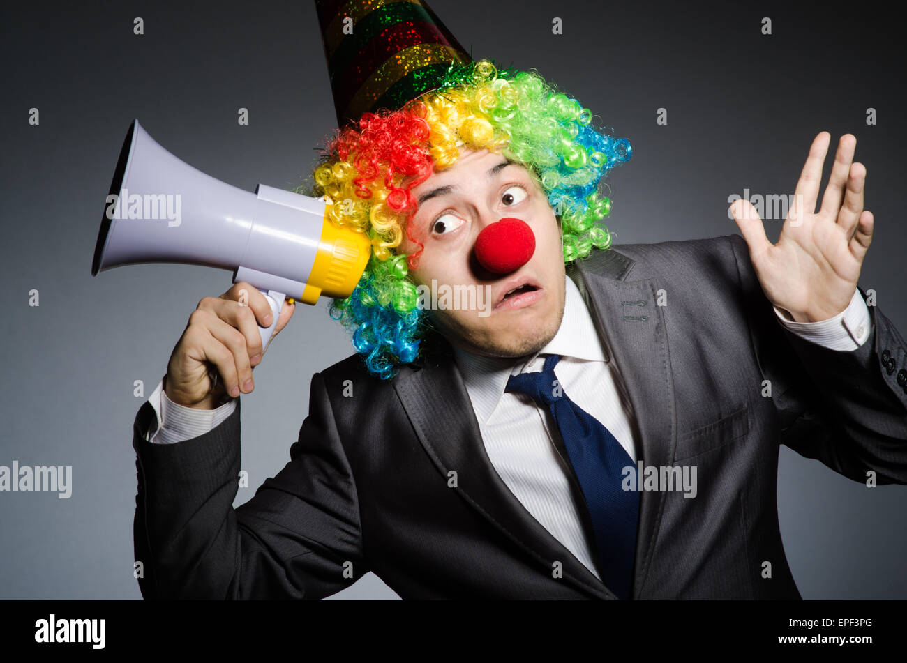 Clown with loudspeaker in funny concept Stock Photo - Alamy