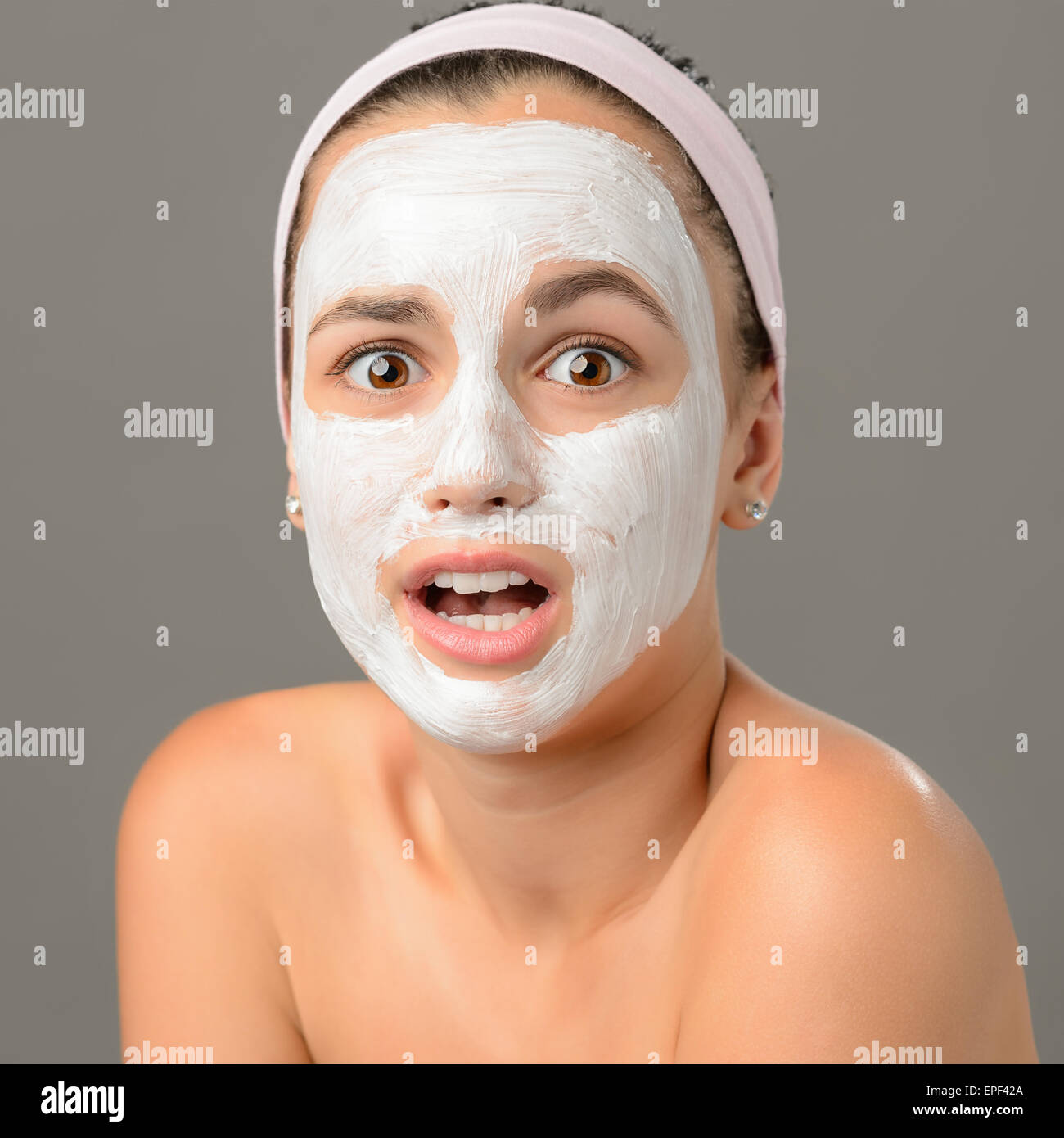 Surprised teenage girl looking camera face mask Stock Photo - Alamy