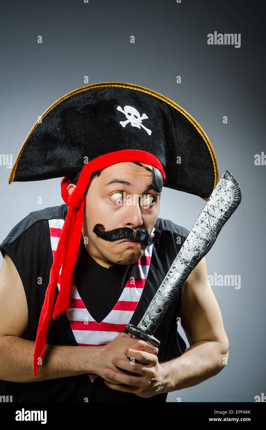 Funny pirate in the dark studio Stock Photo - Alamy