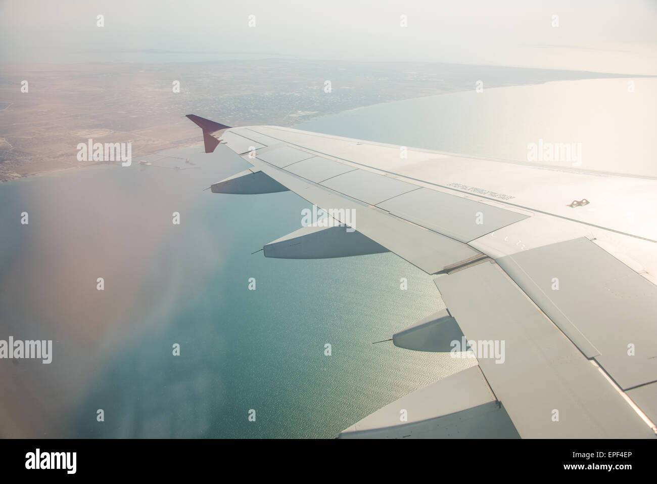 Airplane wing out of window Stock Photo - Alamy