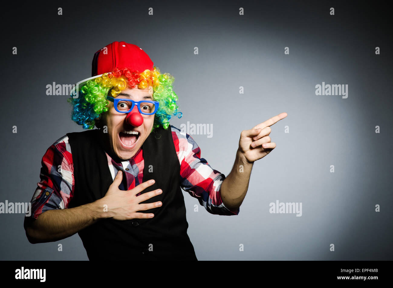 Funny clown against the dark background Stock Photo - Alamy