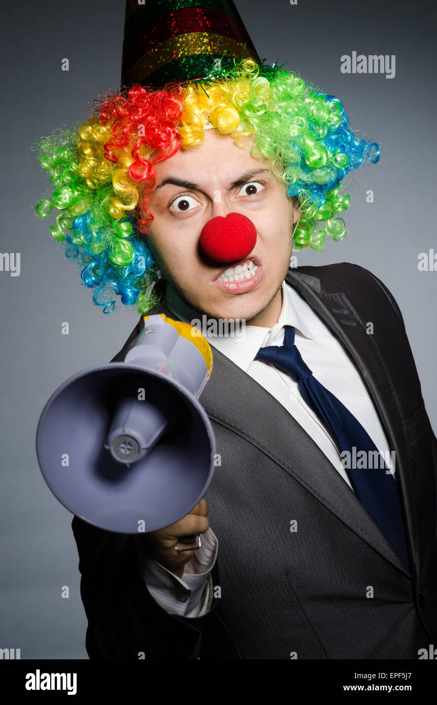 Clown with loudspeaker in funny concept Stock Photo - Alamy