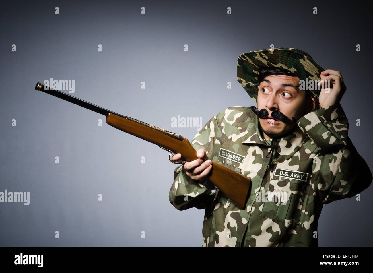 Funny soldier against the dark background Stock Photo - Alamy