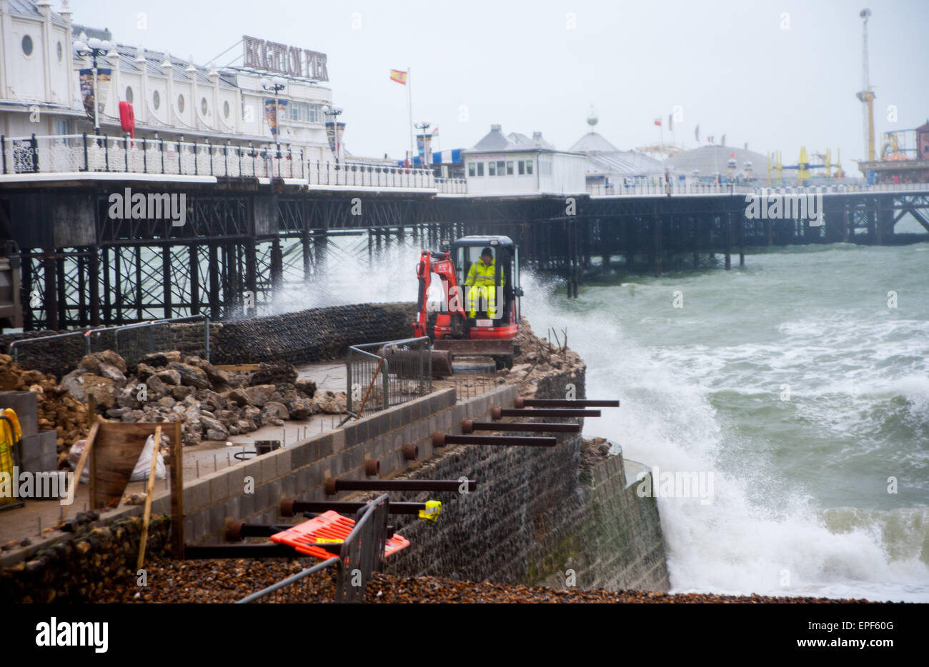 Brighton, UK. 18th May, 2015. Workmen battle against the rough weather ...