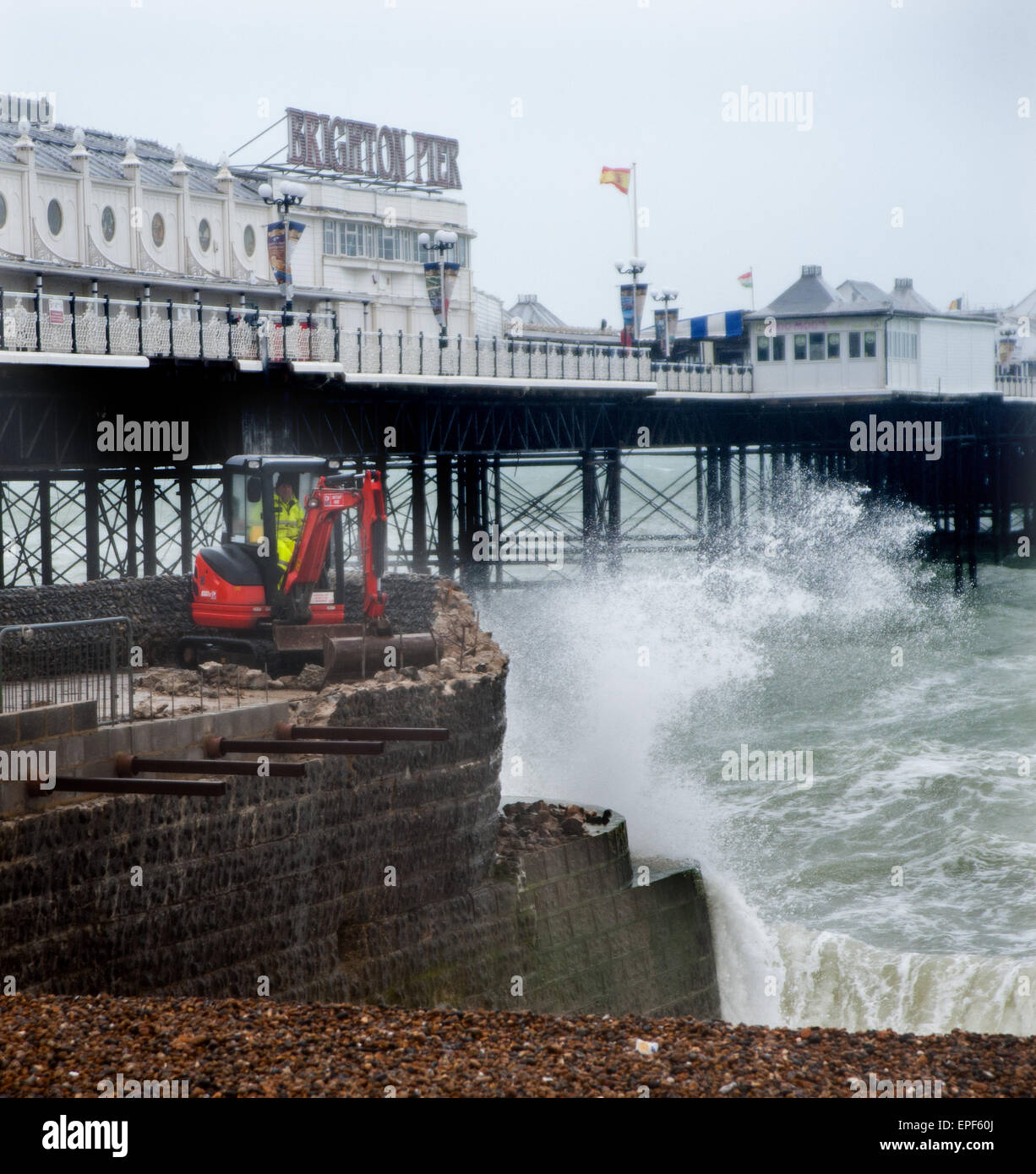 Brighton, UK. 18th May, 2015. Workmen battle against the rough weather ...