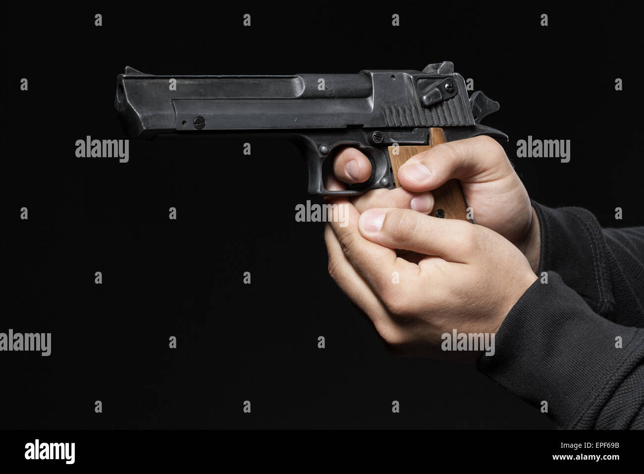 male hands with gun isolated on black background Stock Photo - Alamy