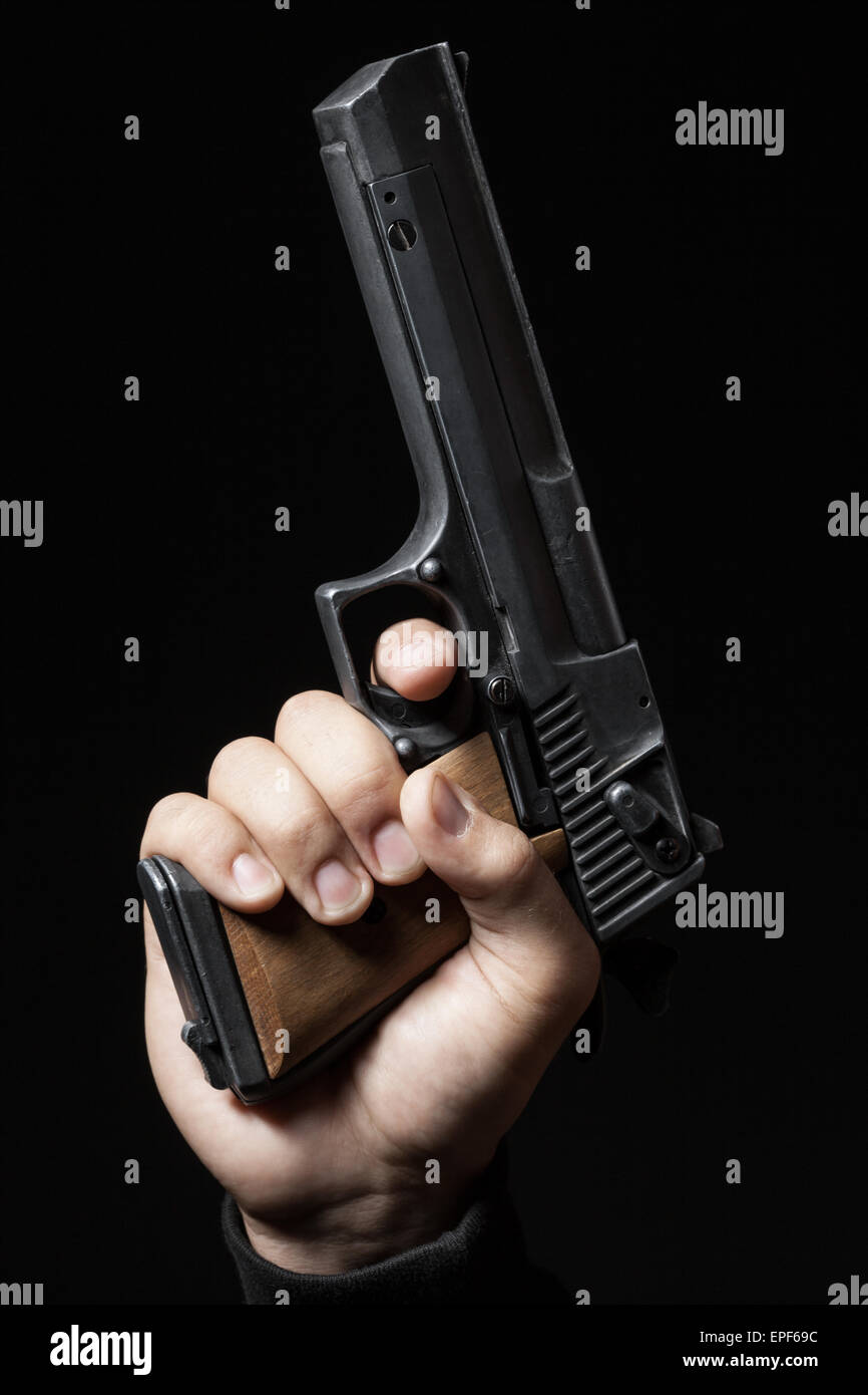 male hand with gun isolated on black background Stock Photo - Alamy