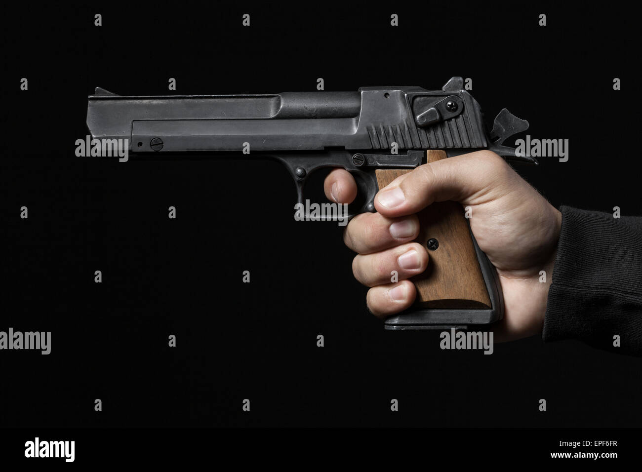 male hand with gun isolated on black background Stock Photo - Alamy