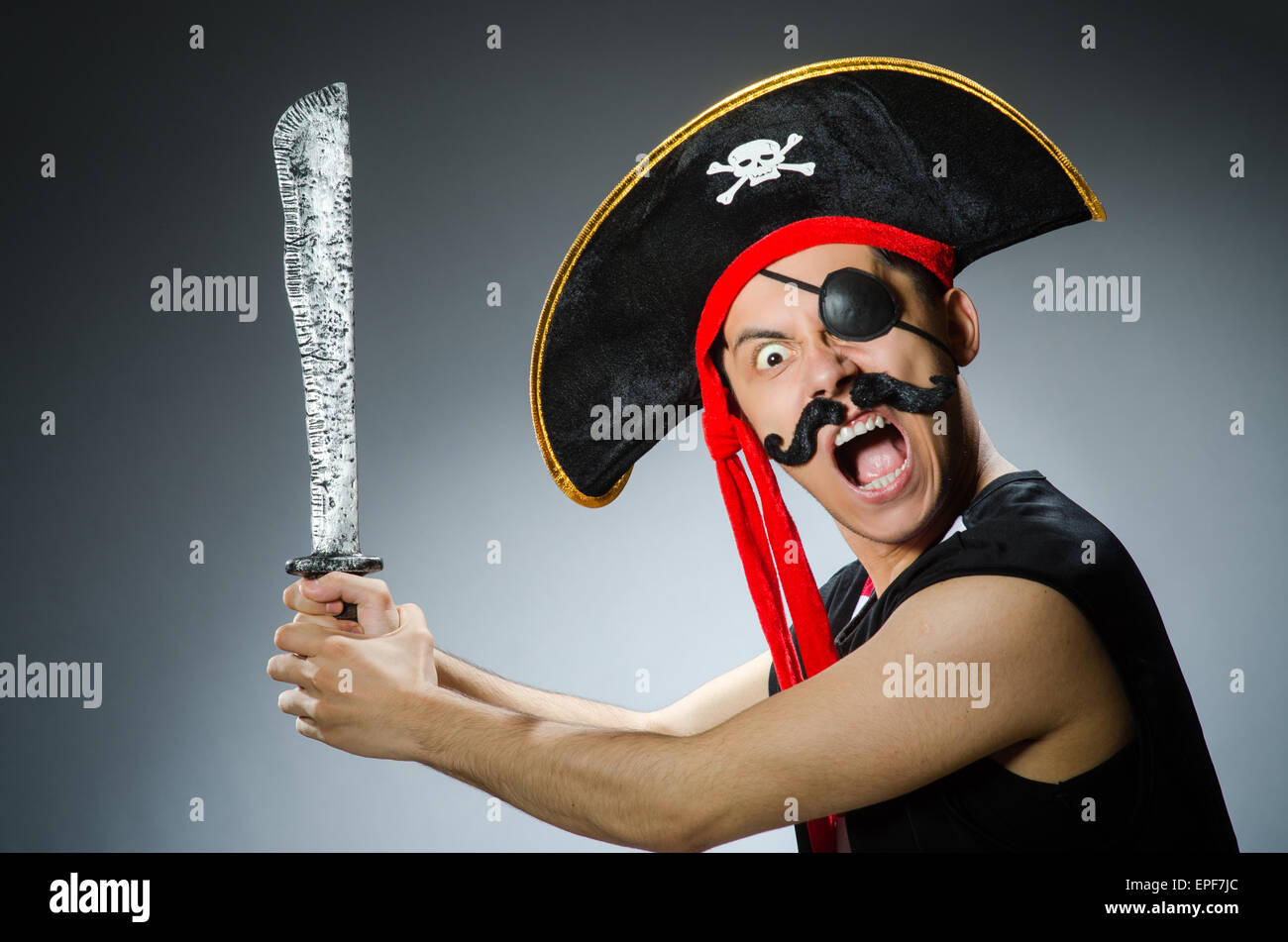 Funny pirate in the dark studio Stock Photo - Alamy