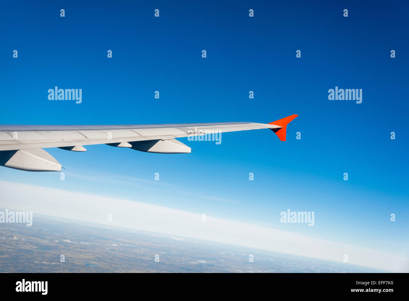 Airplane wing out of window Stock Photo - Alamy