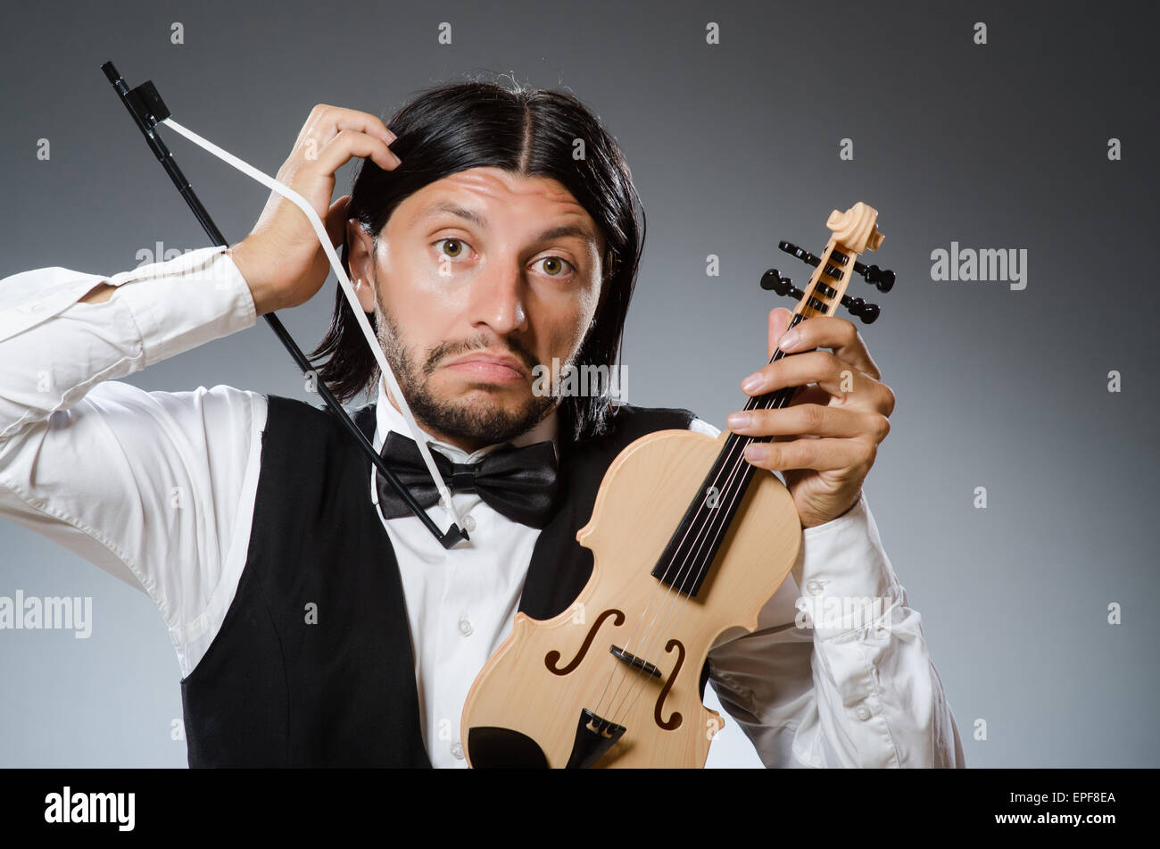 Funny fiddle violin player in musical concept Stock Photo - Alamy