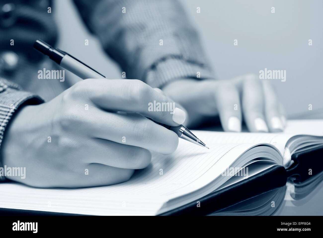 Female hand writing in notebook Stock Photo - Alamy Female hand writing in notebook Stock Photo - Alamy