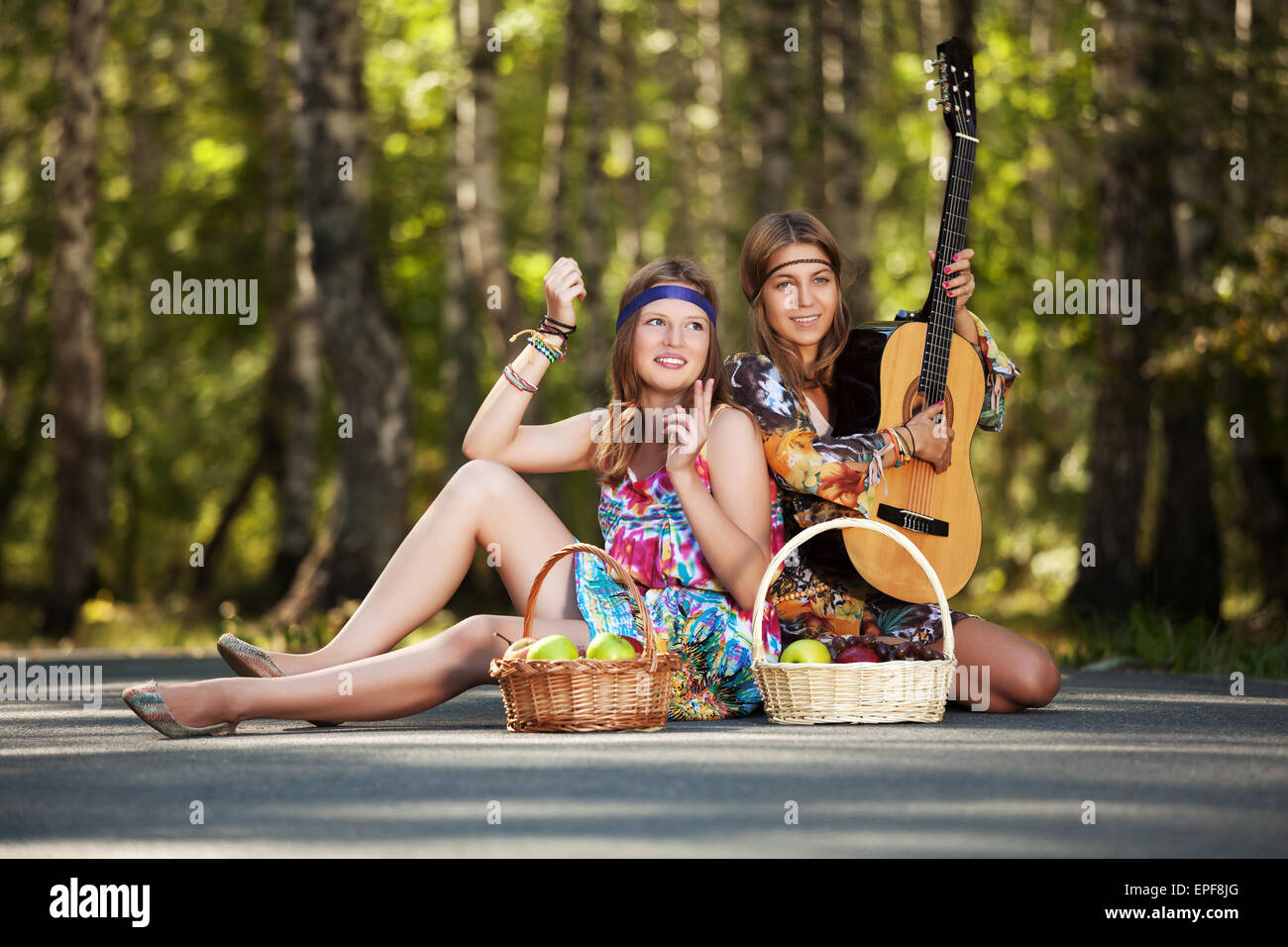 Two hippie girls with guitar in a summer forest Stock Photo - Alamy