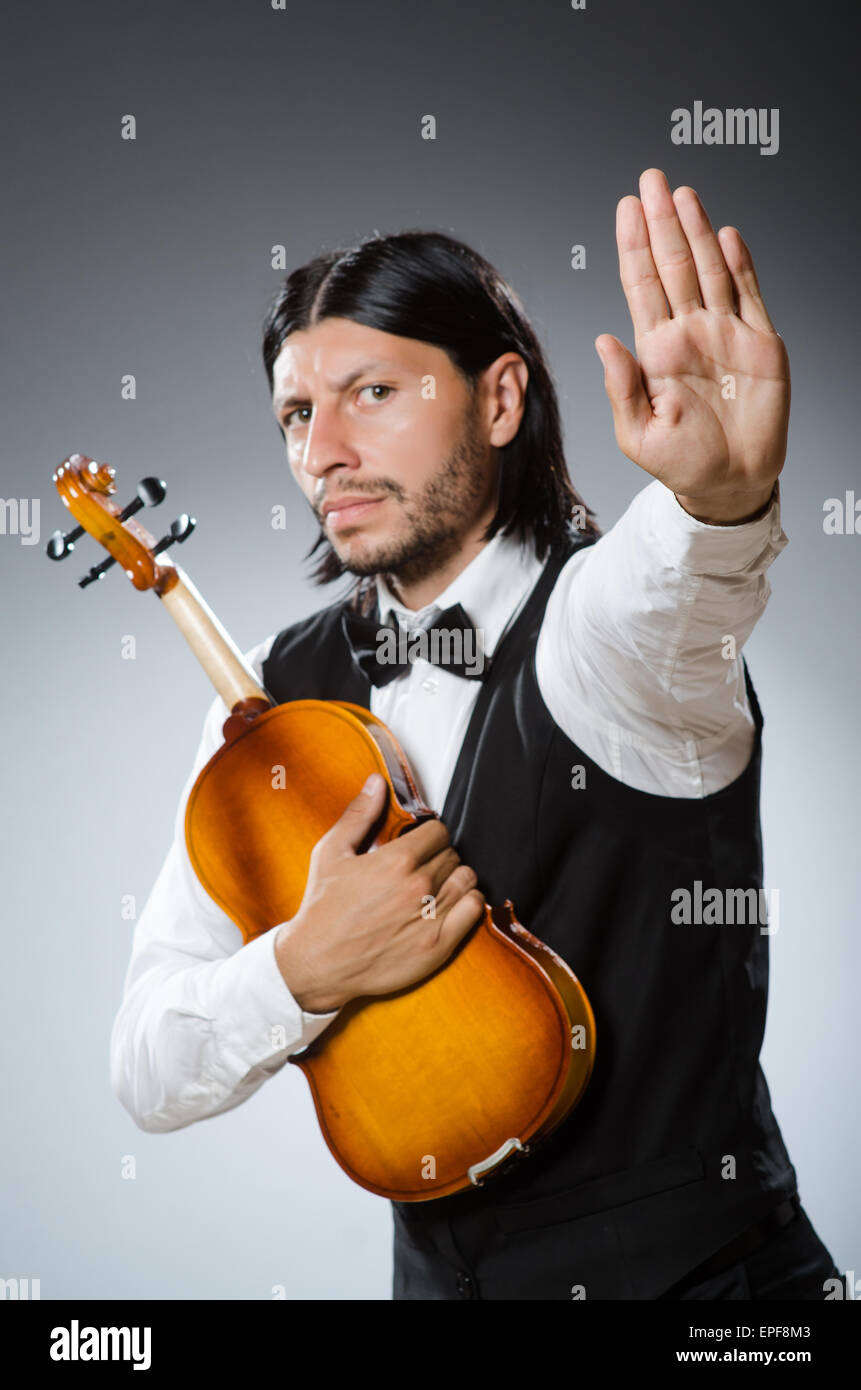Funny fiddle violin player in musical concept Stock Photo - Alamy